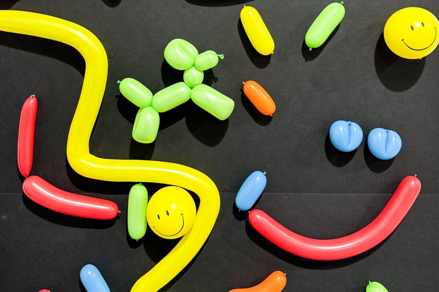 Stick balloons on the wall for an easy party backdrop! Here's how...